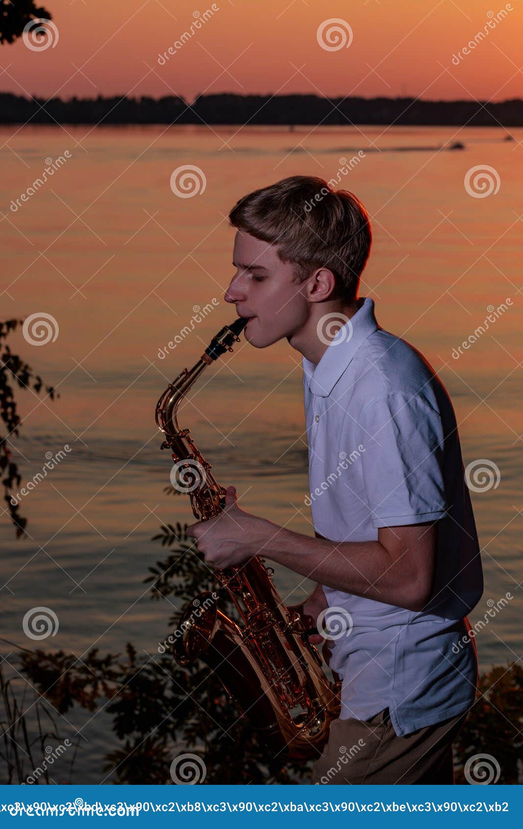 A Young Guy Plays the Saxophone in the Evening at Sunset Stock Image ...