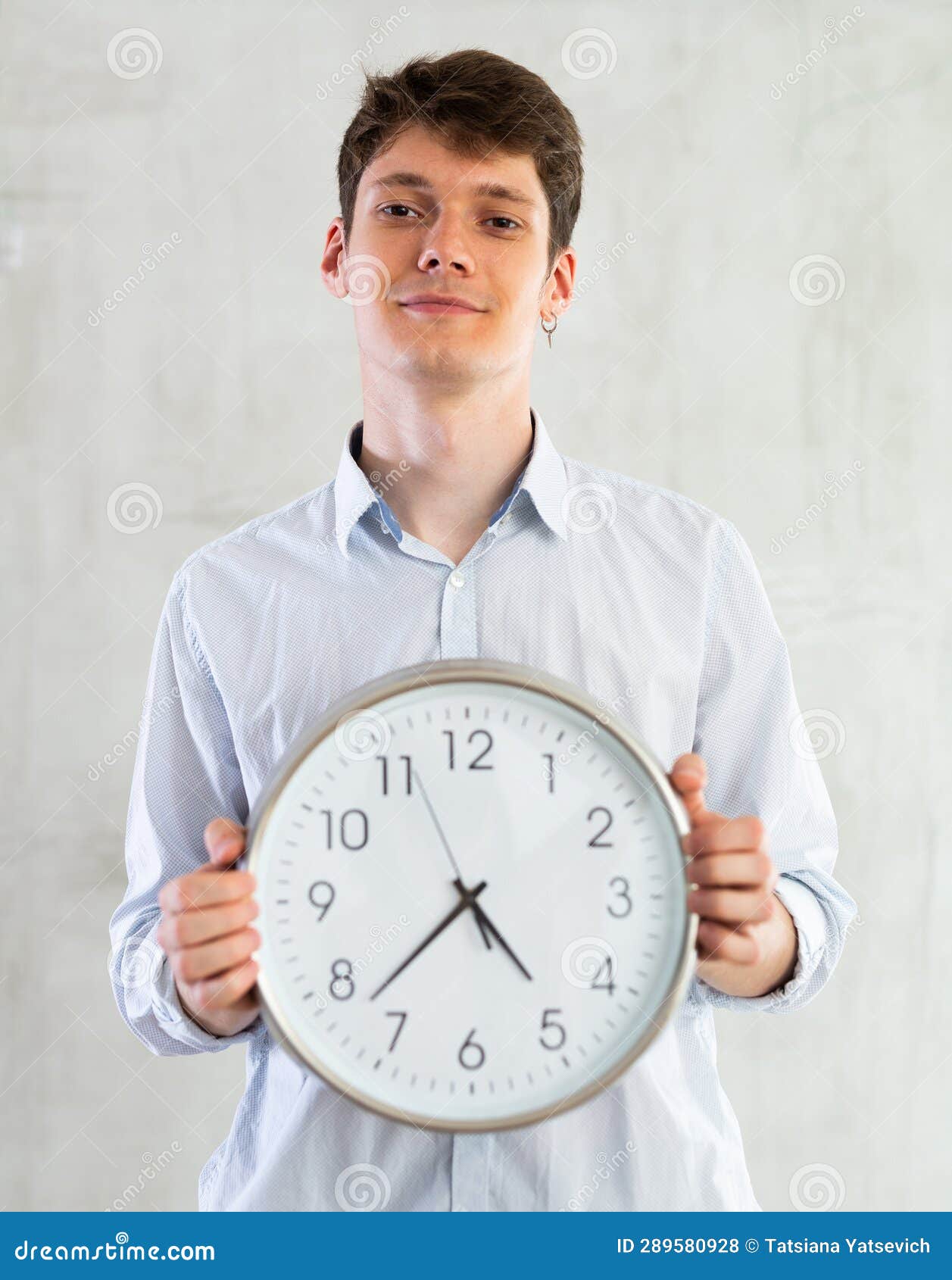 Young Guy Posing with Clock in Studio Stock Photo - Image of closeup ...
