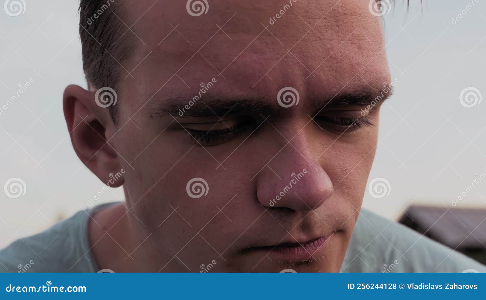 A Young Guy S Face is Close-Up, from Behind Against the Background of a ...