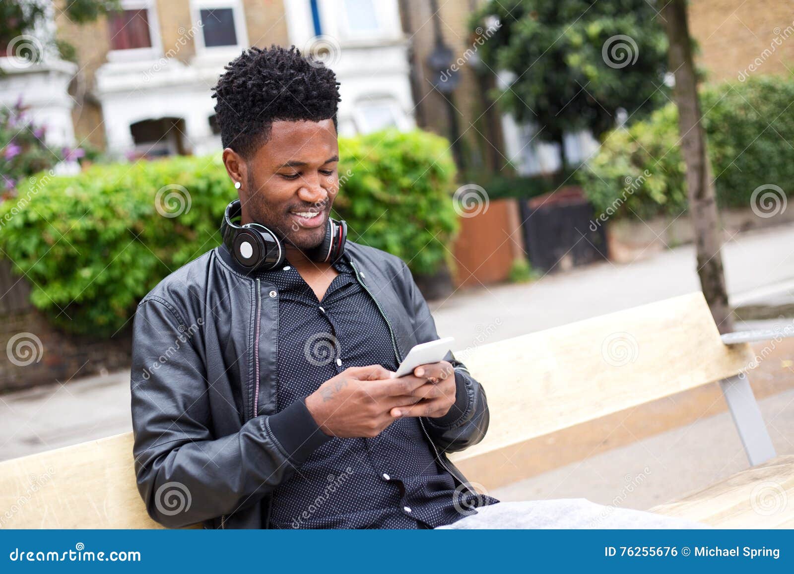Young Guy Sending a Text Message Stock Photo - Image of cell, outdoors ...