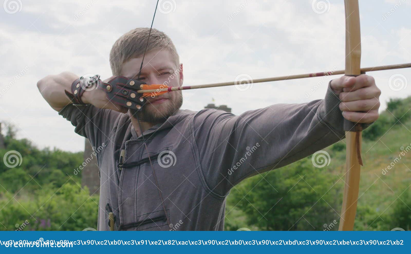 A Young Guy Shoots a Bow at a Target, in Nature, and Hits the Target ...