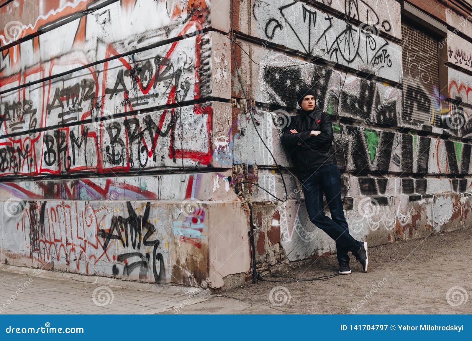 A Young Guy is Standing Next To Wall with Graffiti Stock Image - Image ...