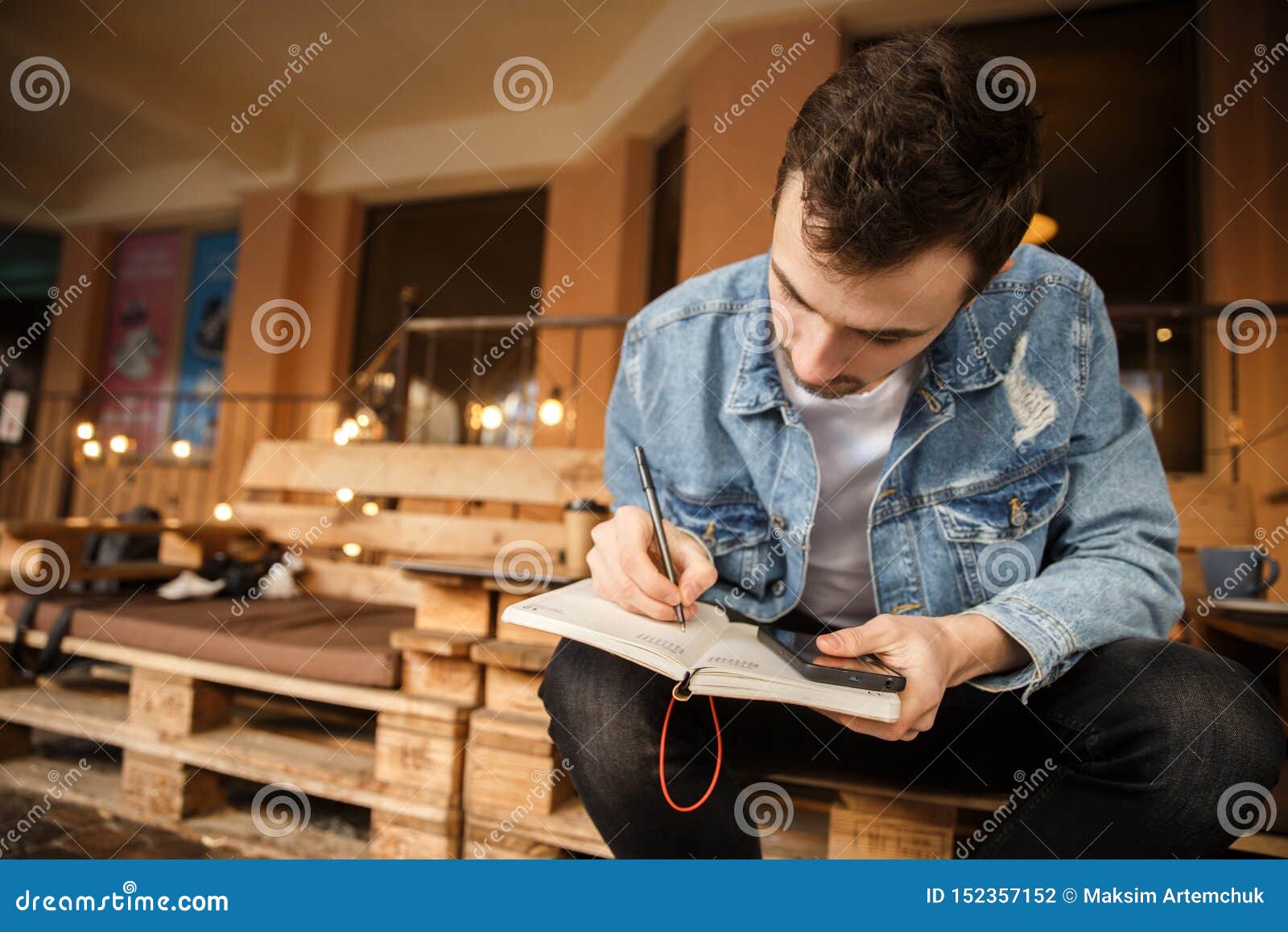 A Young Guy is Taking Notes while Sitting on the Cafe Terrace Stock ...