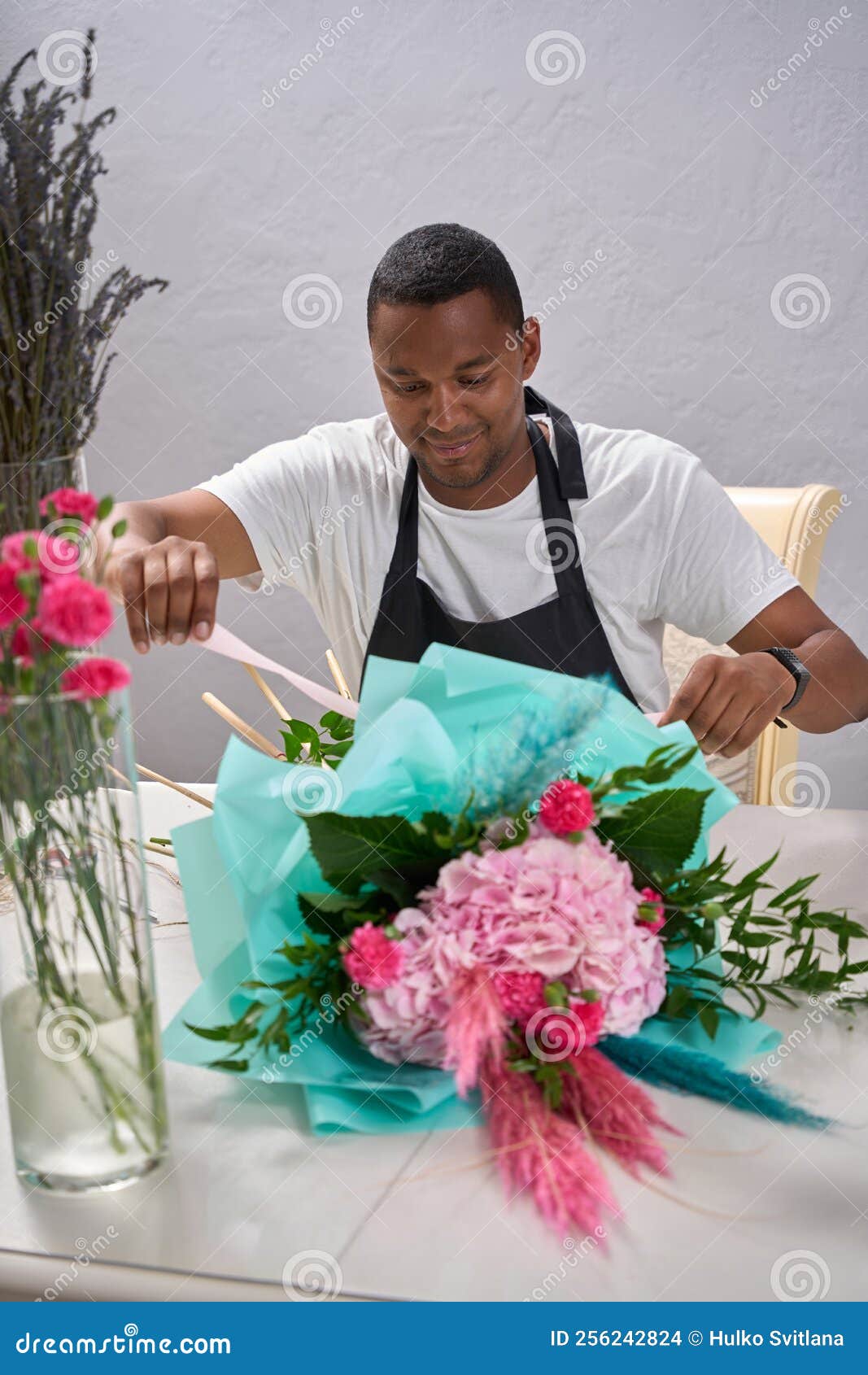 Young Guy Tying a Bouquet with a Ribbon Stock Photo - Image of market ...