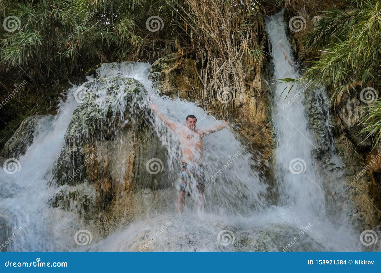 Young Guy Under the Streams of a Waterfall Stock Photo - Image of river ...