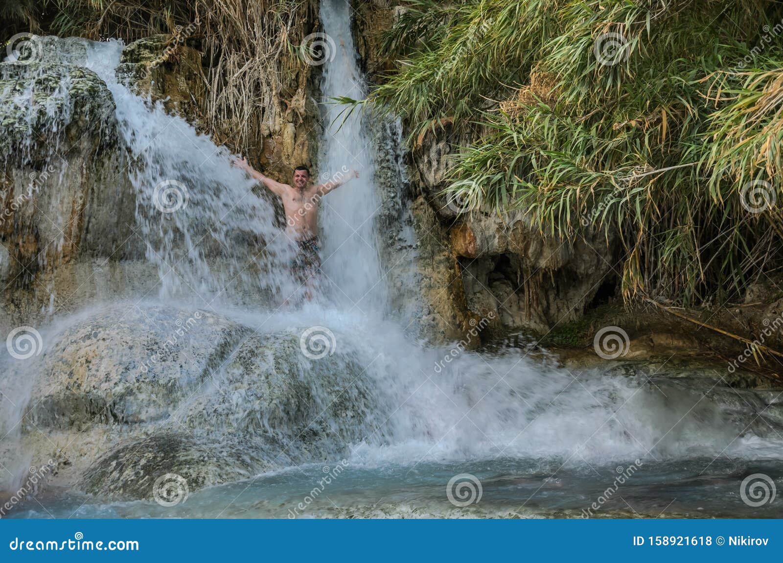 Young Guy Under the Streams of a Waterfall Stock Photo - Image of pool ...