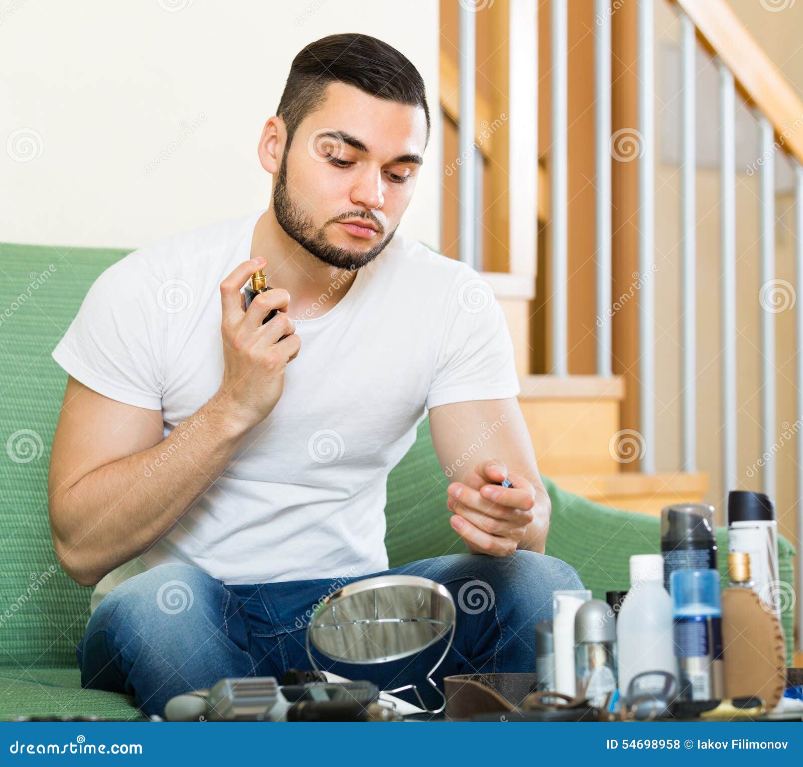 Young Guy Using Perfume at Home Stock Photo - Image of smelling, adult ...