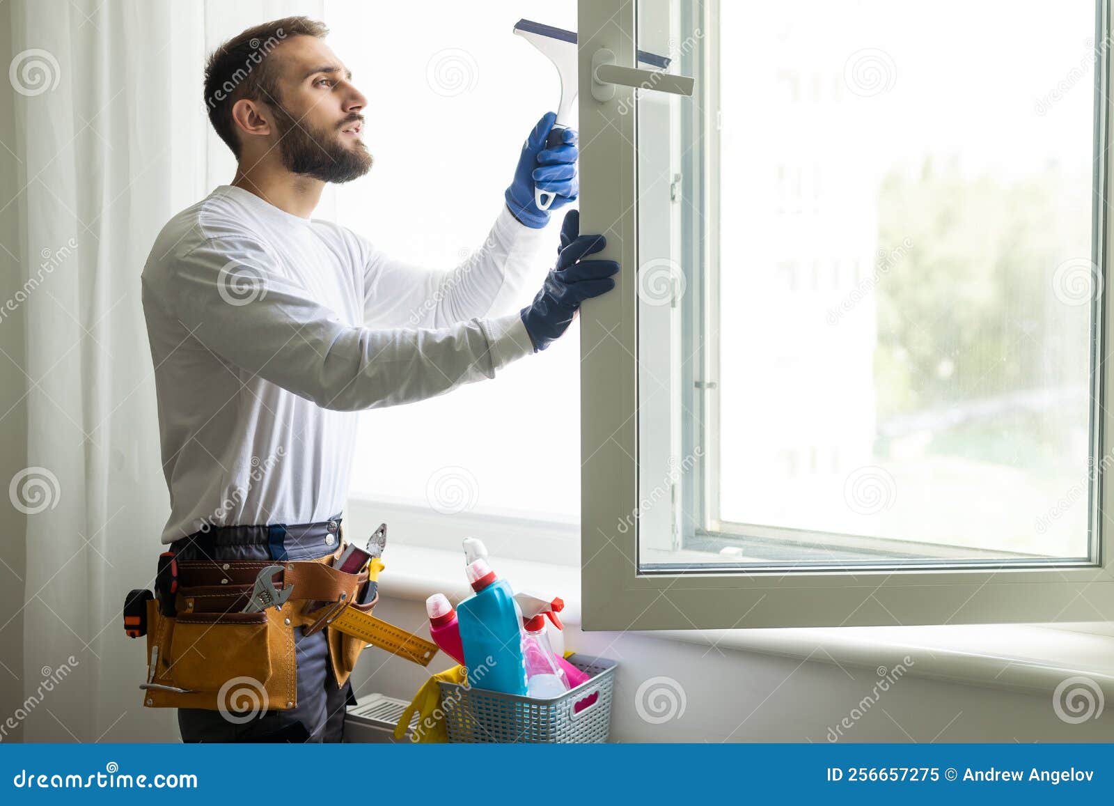 A Young Guy Washes the Window. Window Cleaner Concept Stock Image ...