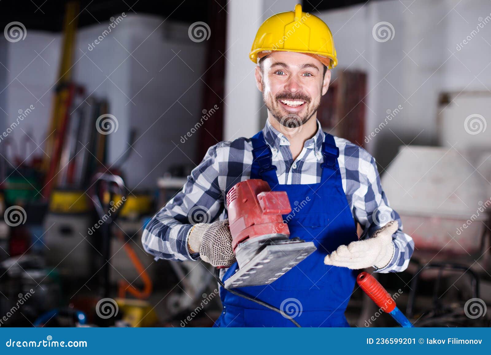 Young Guy Worker is Using Grinder for Construction Work Stock Image ...