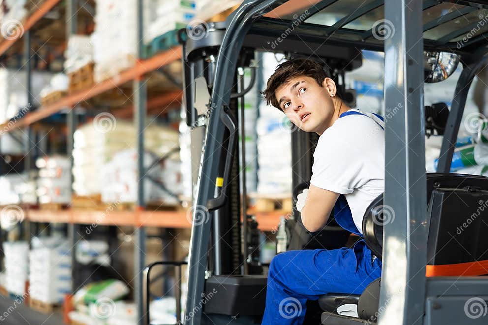 Young Guy Worker Works on Loader in Warehouse Stock Image - Image of ...