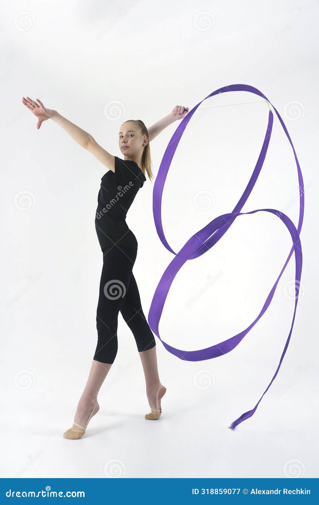 Young Gymnast in a Photo Studio Shows the Elements of Exercises with a ...