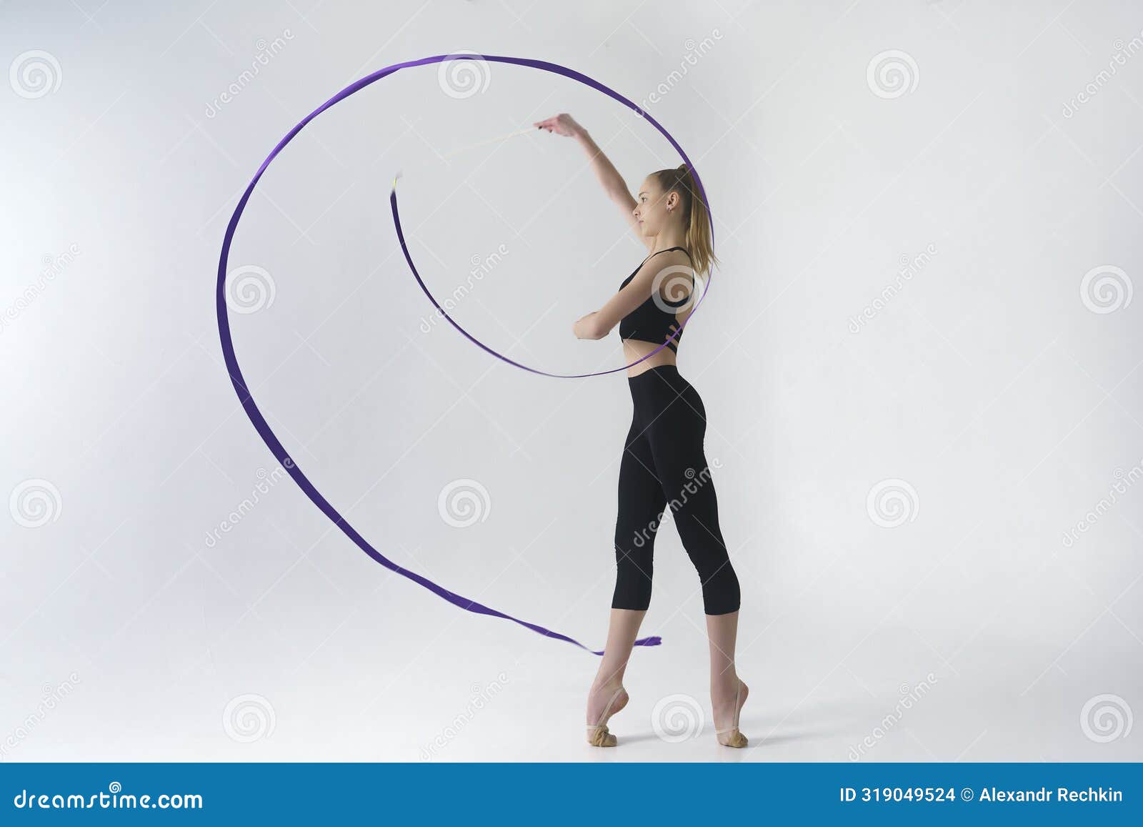 Young Gymnast in a Photo Studio Shows the Elements of Exercises with a ...