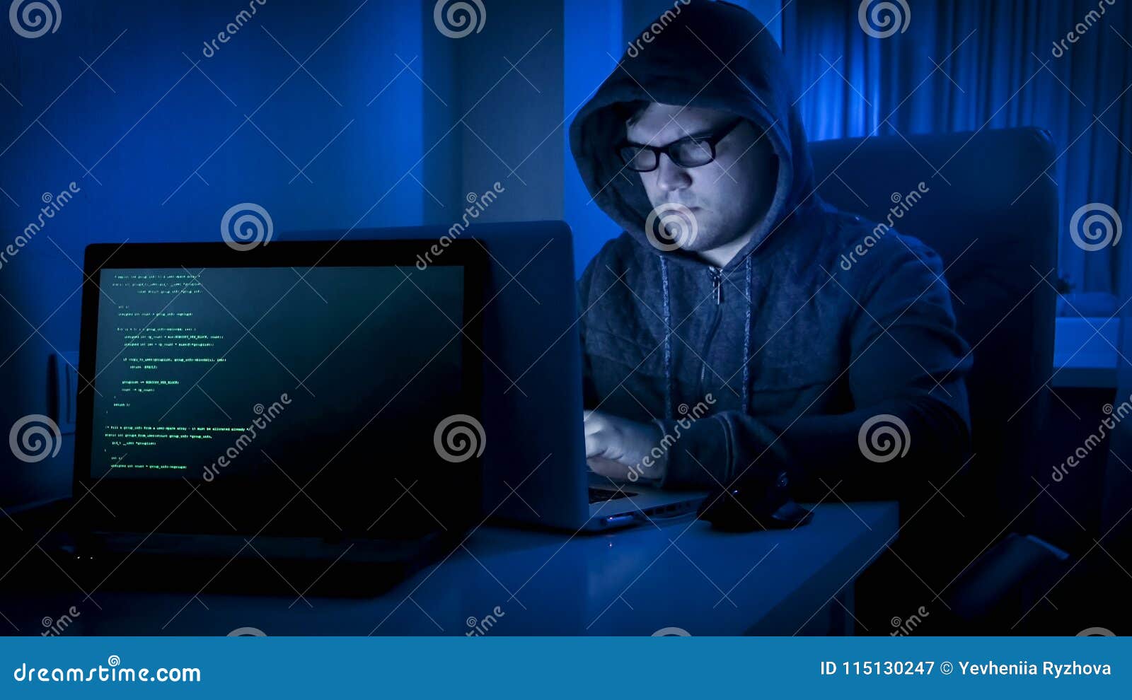 Portrait of Young Hacker Sitting in Dark Room and Working on Laptop ...