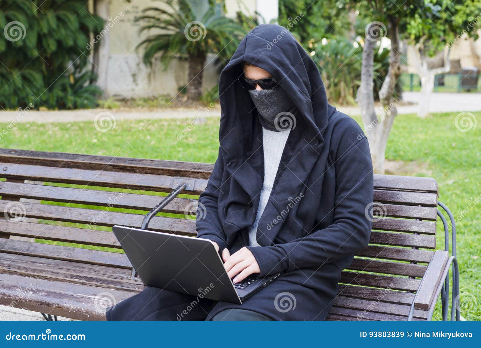 Young Hacker Working on His Laptop Sitting on a Bench in a Park Stock ...
