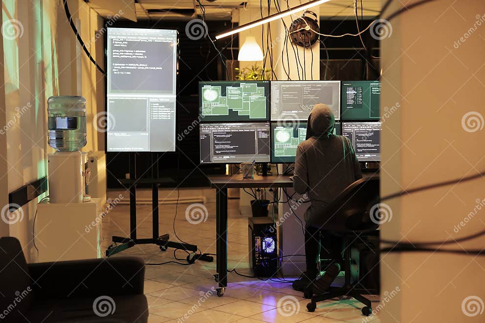 Young Hacker Working on Multiple Monitors To Hack Online Server Stock ...