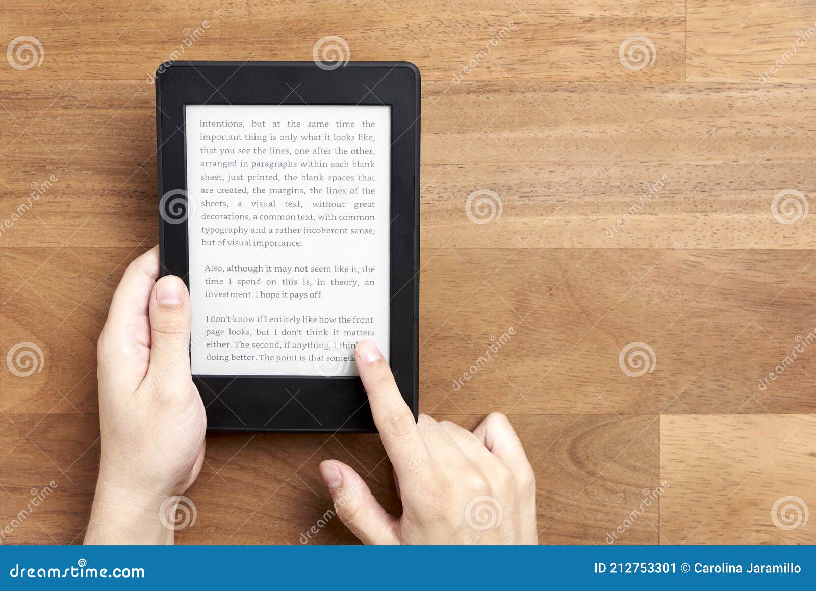 Young Hands Holding an Electronic Reader and Turning the Page of the E ...