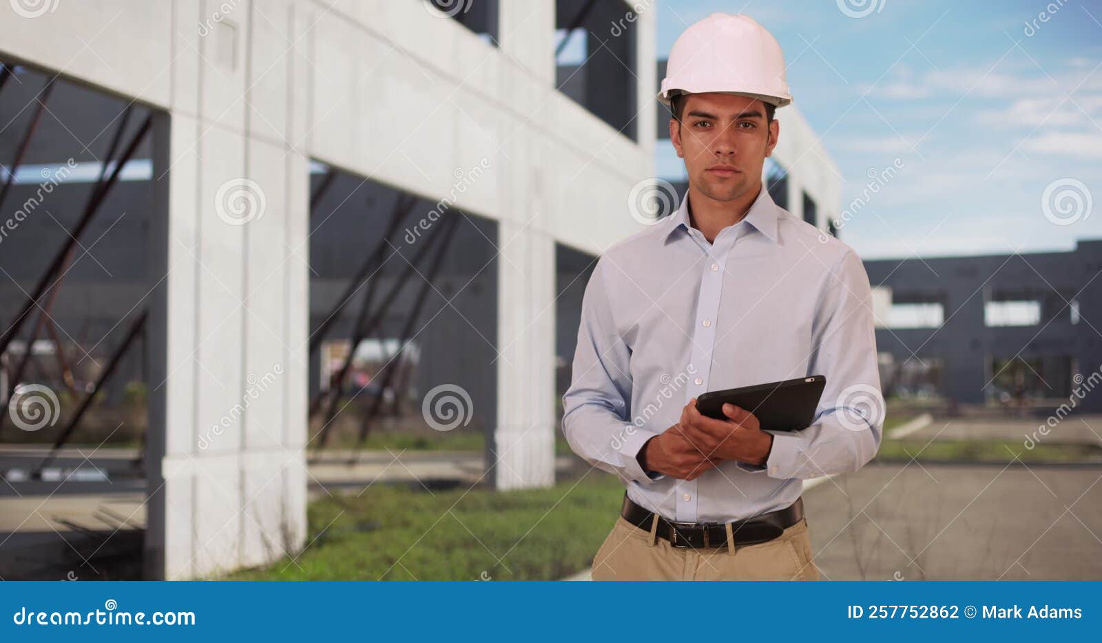 Young Handsome Architect at Construction Site Holding Modern Tablet ... Young Handsome Architect at Construction Site Holding Modern Tablet ...