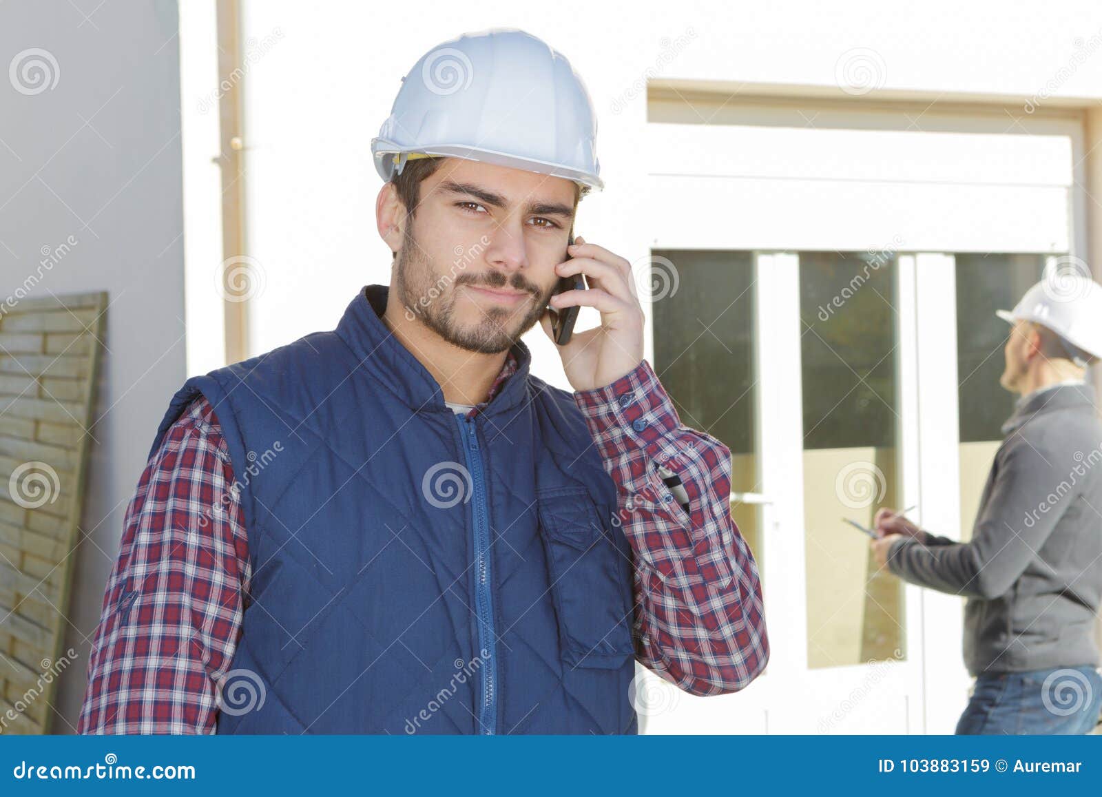 Young Handsome Architect Supervising Construction Site Using Cell Phone ...