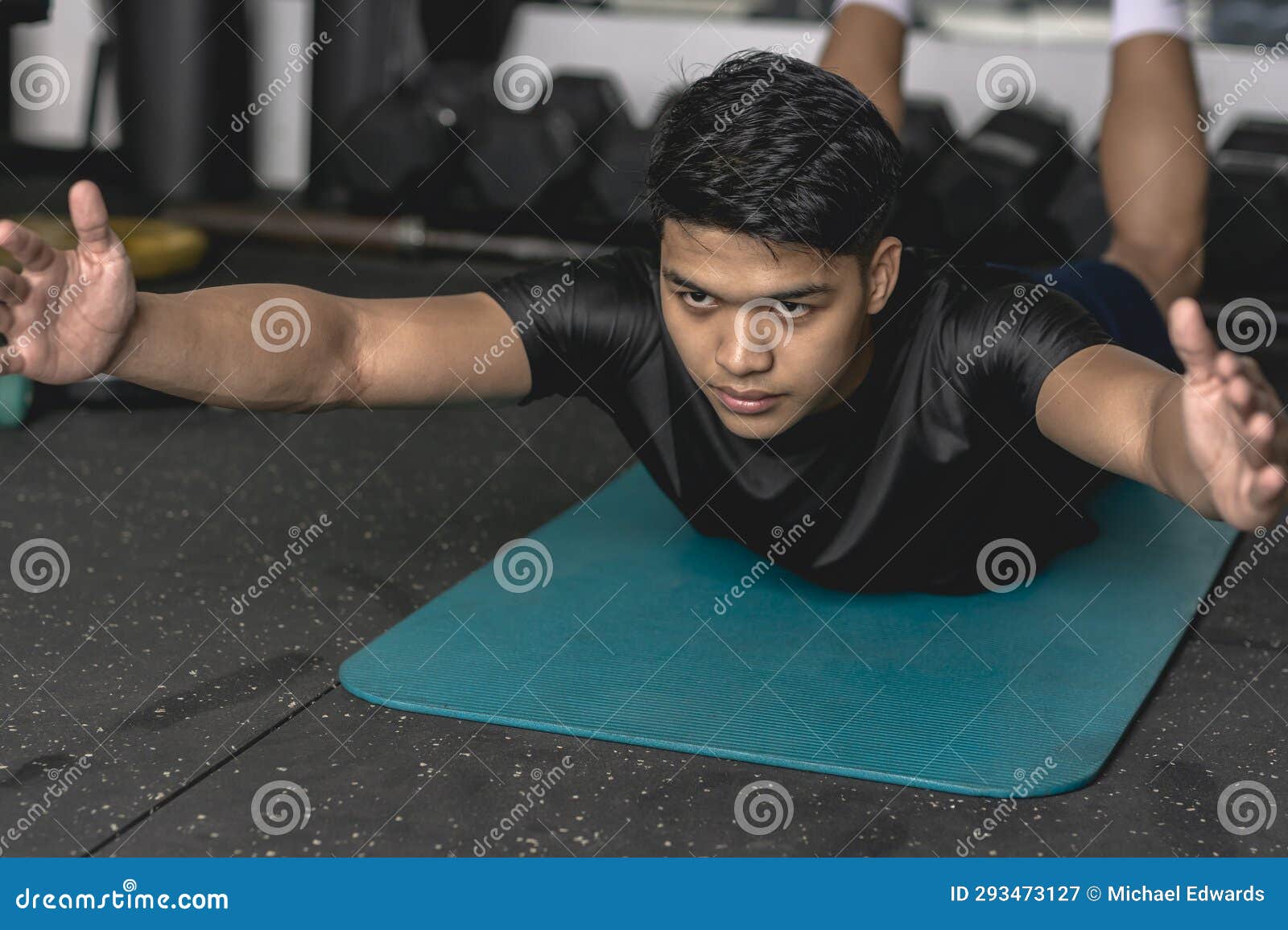 A Young Handsome Asian Man Does Superman Back Extension Exercises while ...