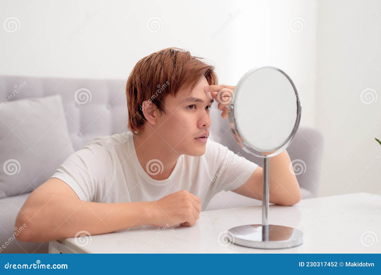 Young Handsome Asian Man Looking at His Face in the Mirror Isolated ...