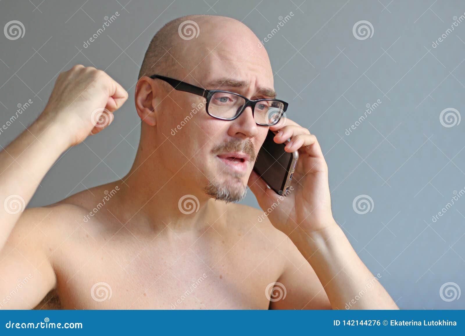 Young Handsome Bald Man In Black Glasses Talking On The Phone Closeup