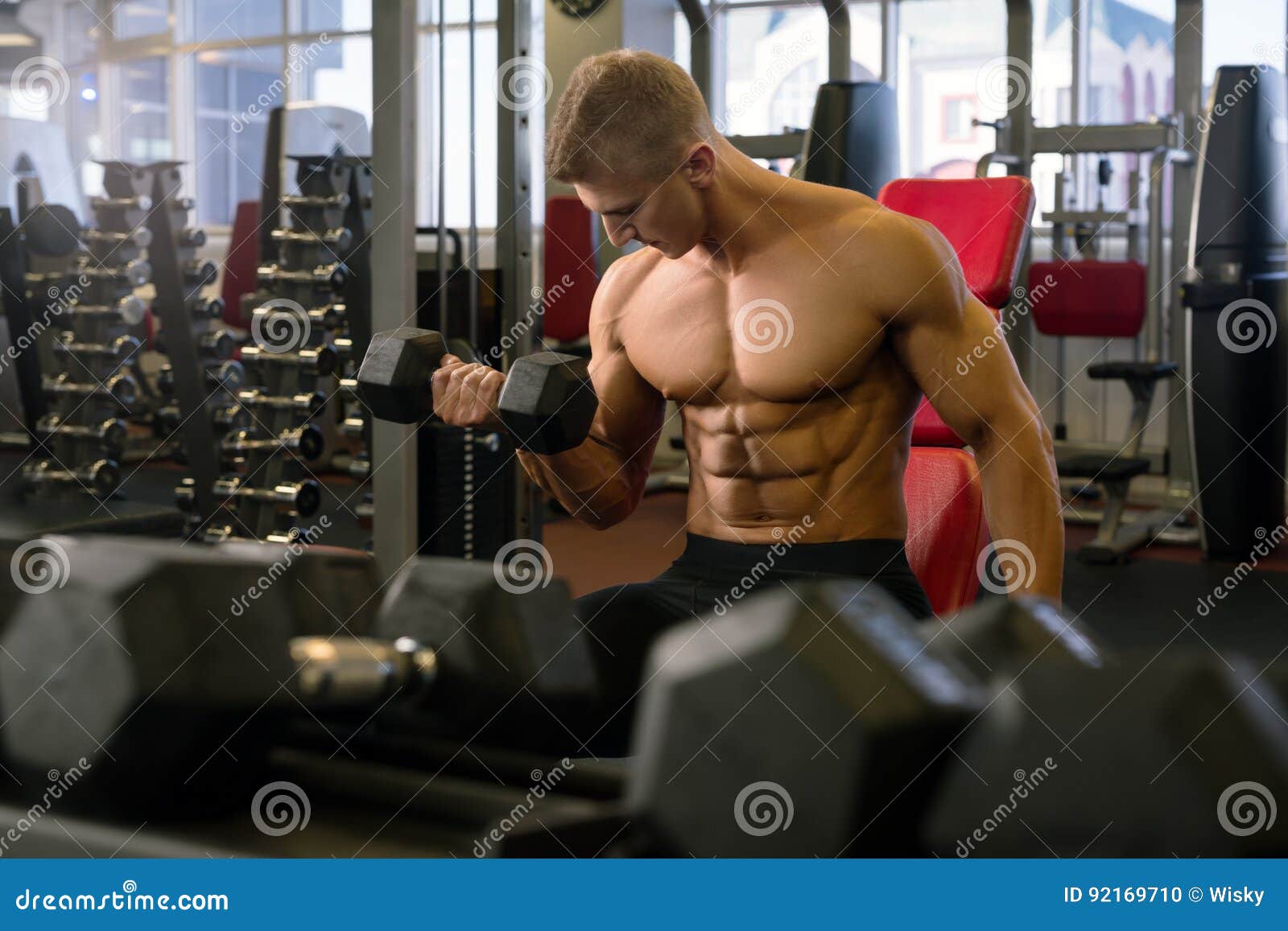 Young Handsome Bodybuilder Exercising with Dumbell Stock Photo - Image ...