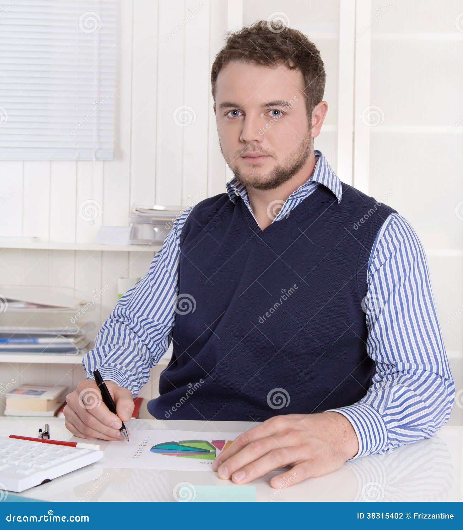 Young Handsome Bookkeeper Working with Graphs at Desk. Stock Photo ...