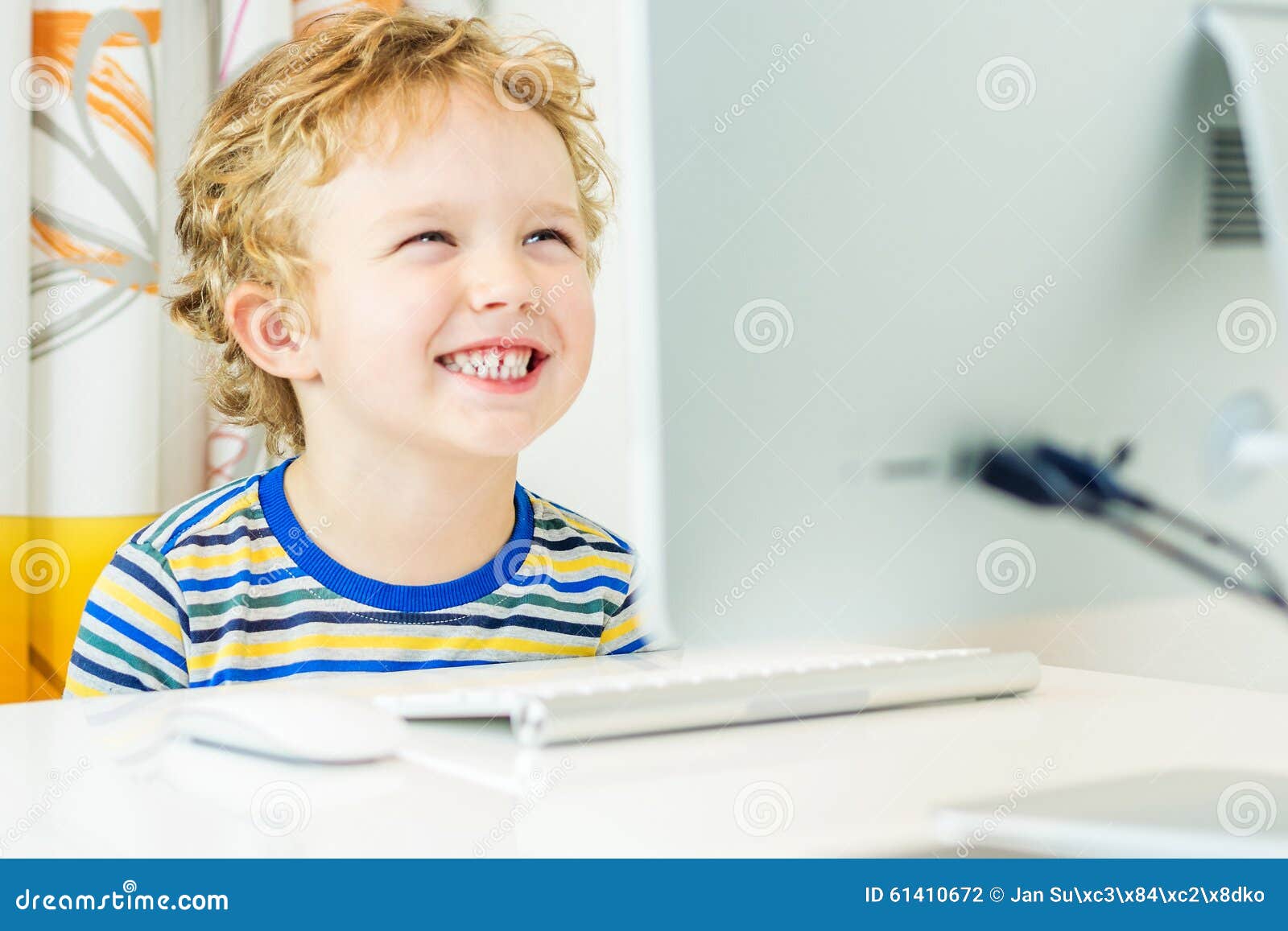 Young Handsome Boy is Watching on a Computer Screen and Laughing Stock ...