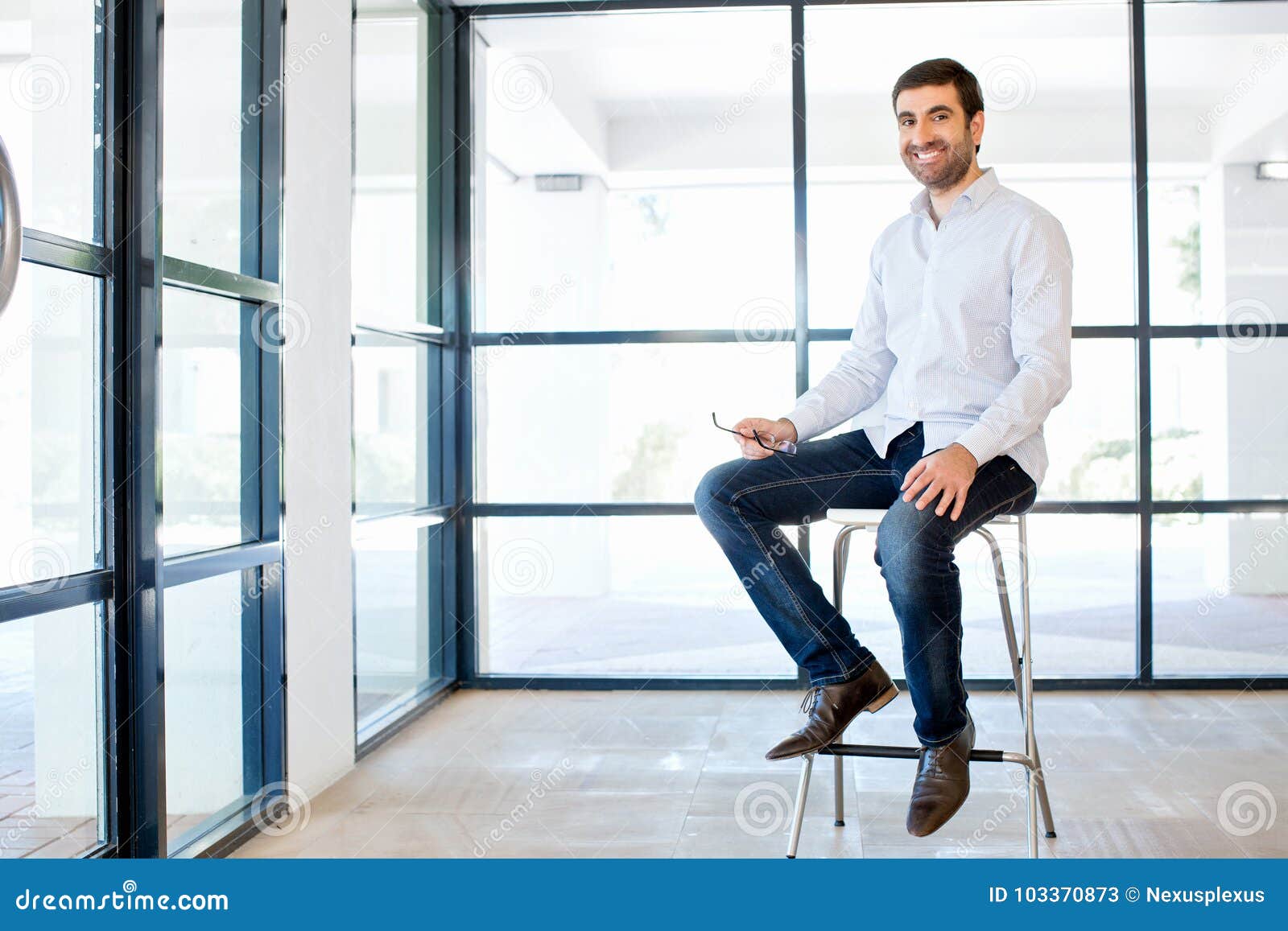Young Business Man Sitting on a Stool in Office Stock Image - Image of ...