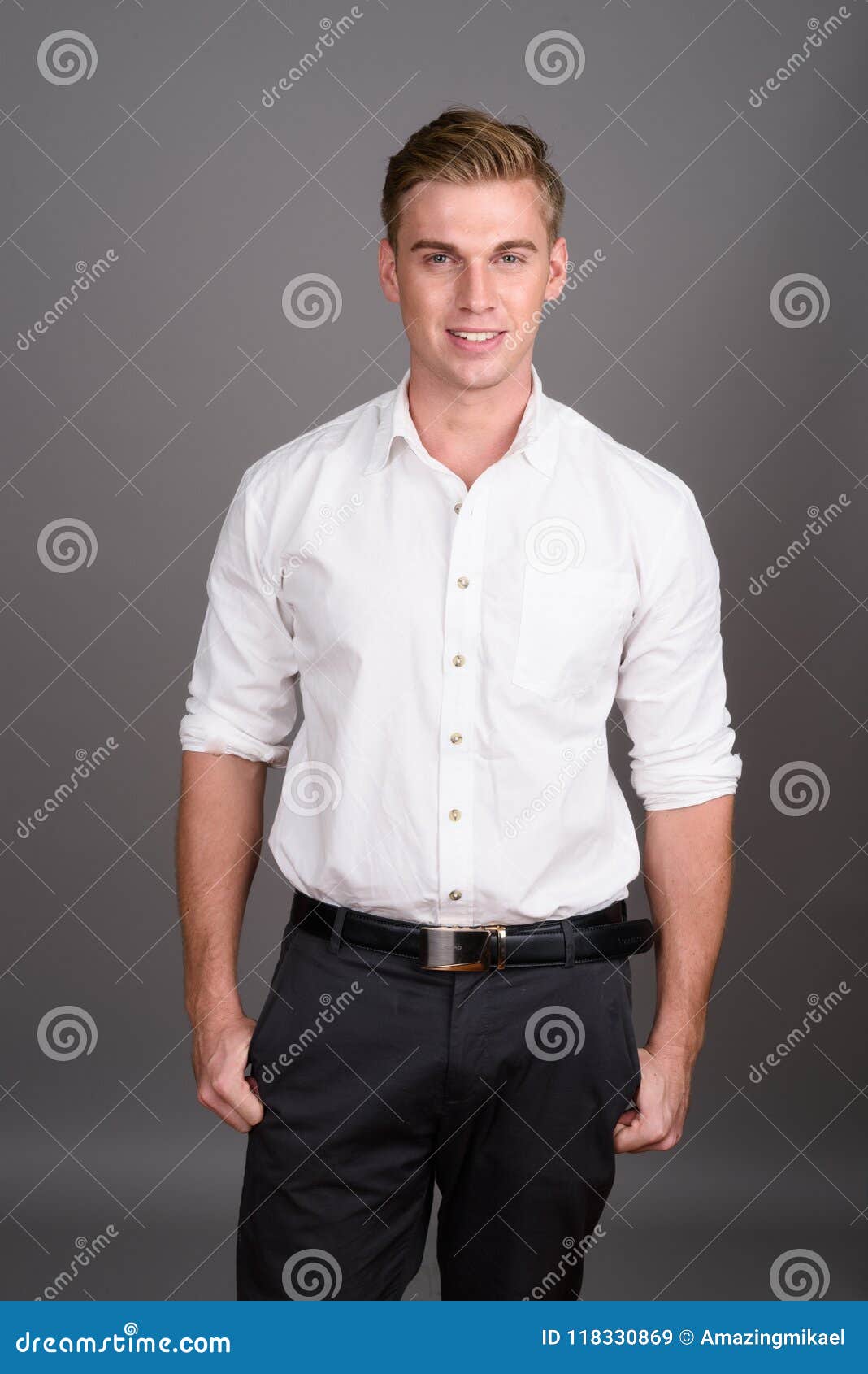 Young Handsome Businessman With Blond Hair Against Gray Backgrou Stock