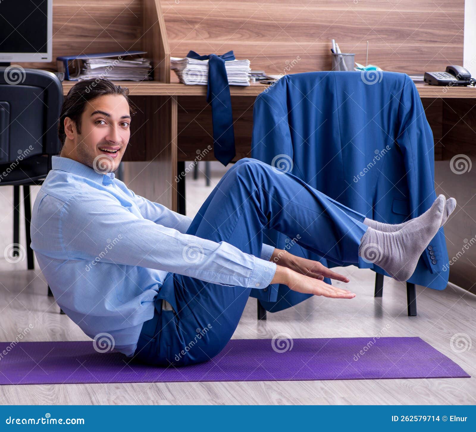 Young Handsome Businessman Doing Exercises at Workplace Stock Photo ...