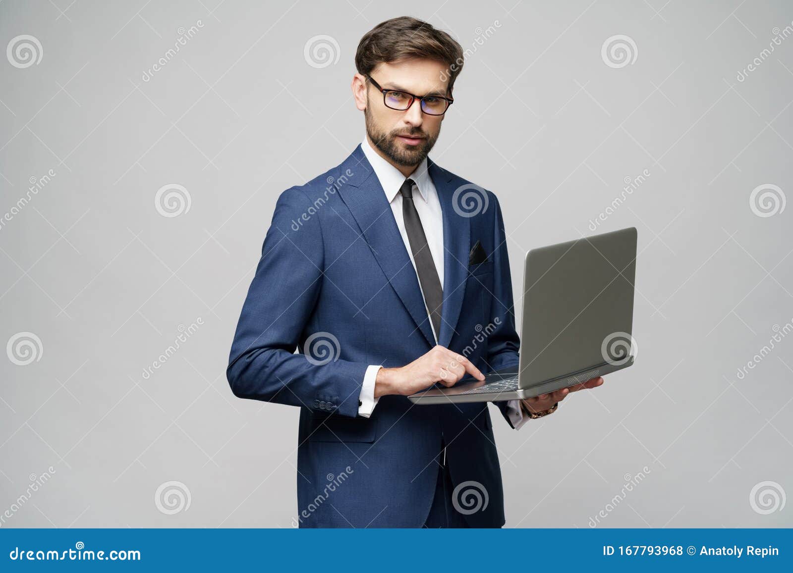 Young Handsome Businessman Holding a Laptop Computer with Blank Screen ...