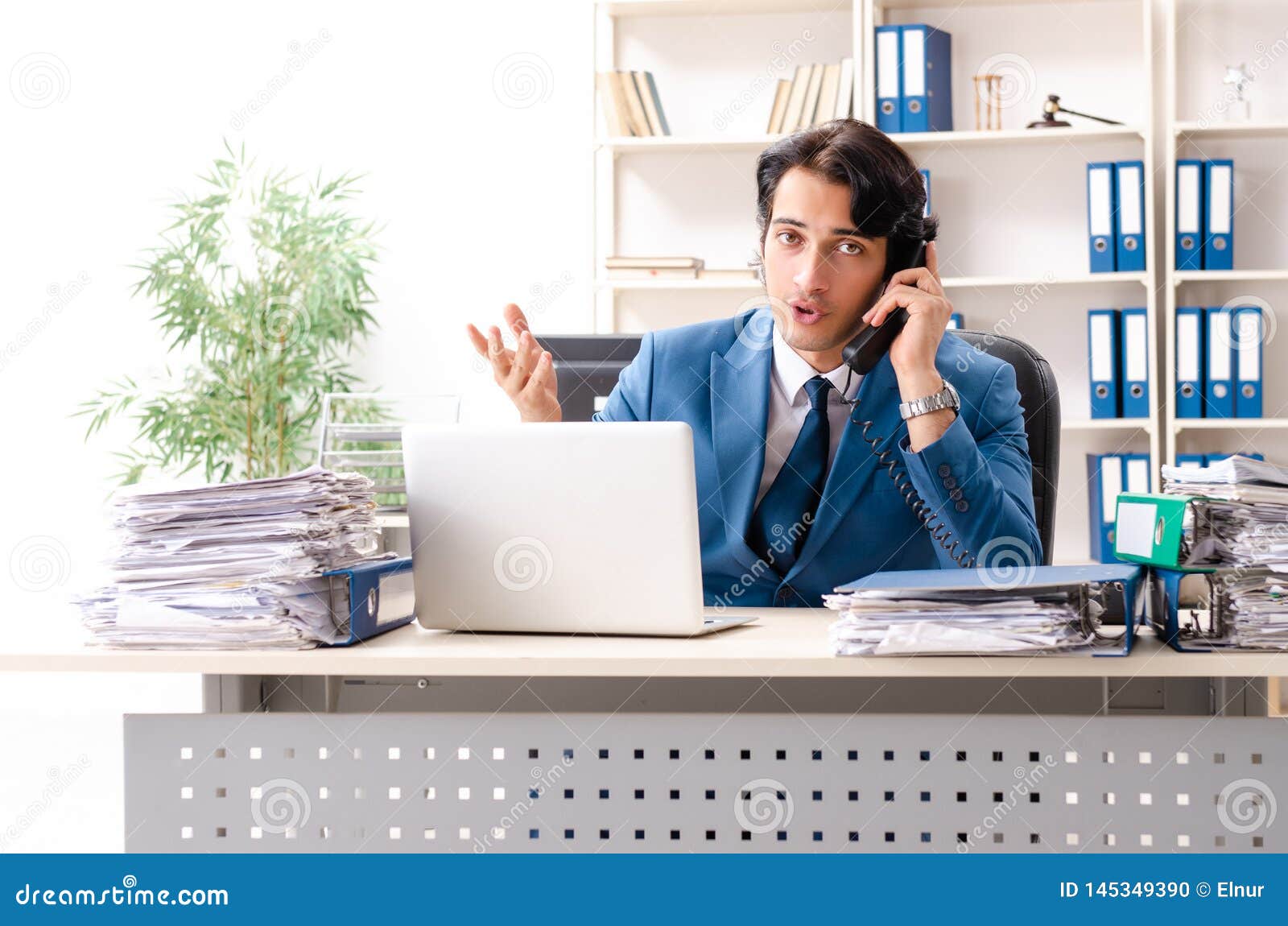 The Young Handsome Busy Employee Sitting in Office Stock Photo - Image ...
