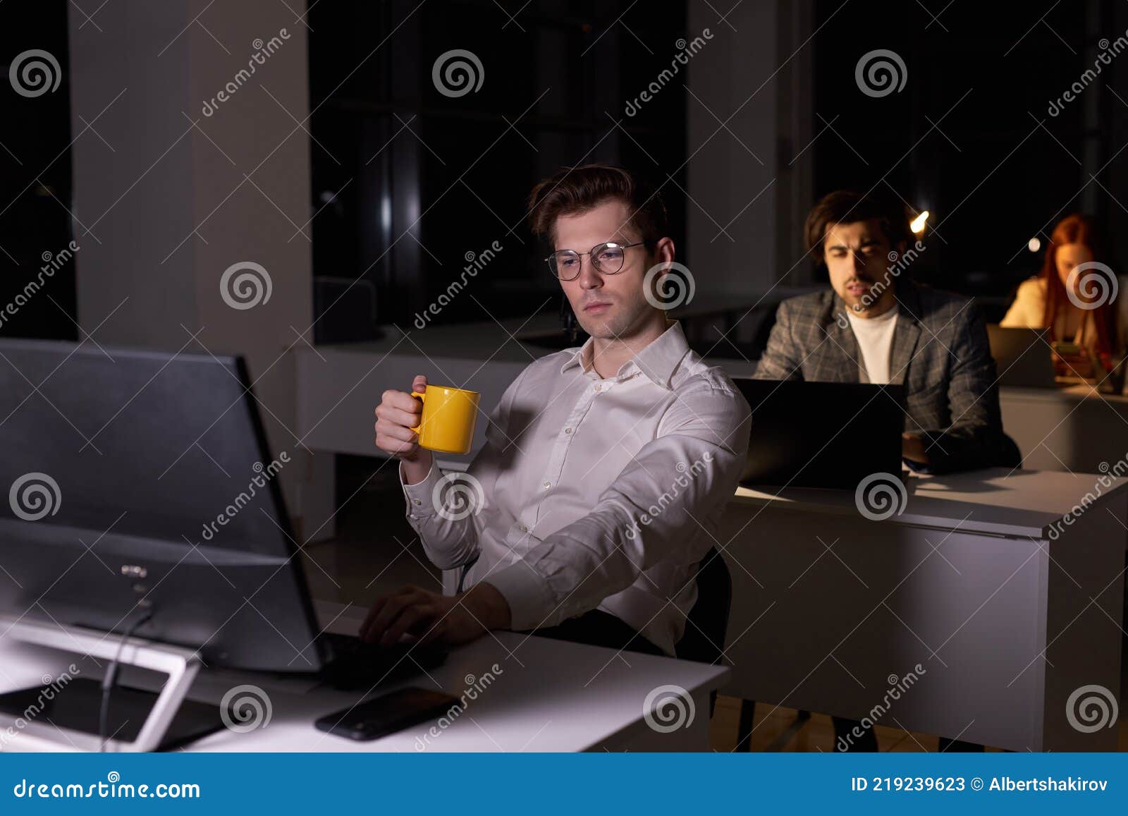 Young Handsome Caucasian Guy Drinking Coffee and Working in Office at ...