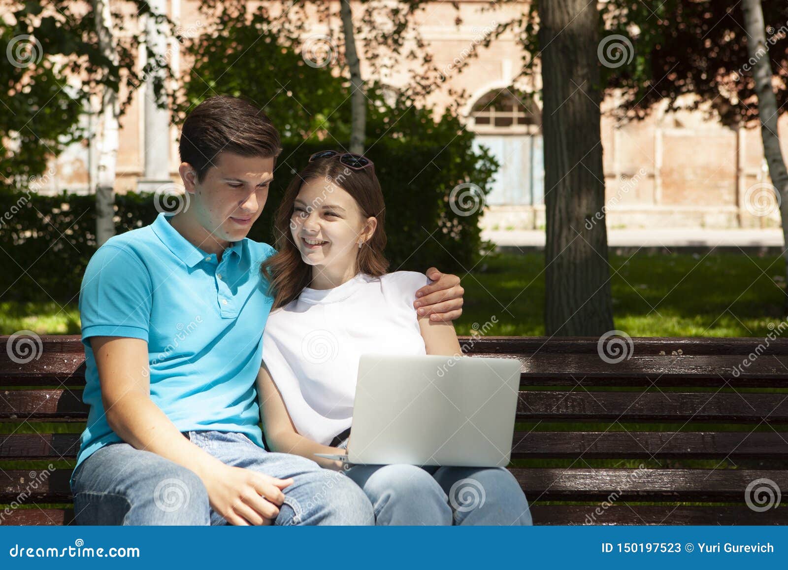 Young Handsome Couple Using Notebook in the Public Park Stock Image ...