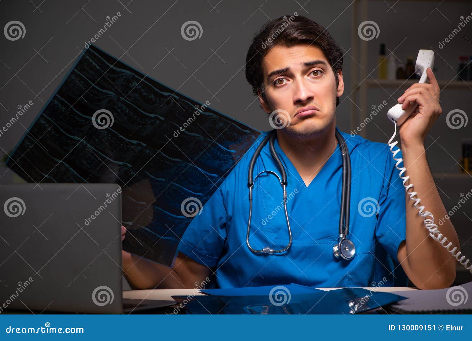 The Young Handsome Doctor Working Night Shift in Hospital Stock Image ...