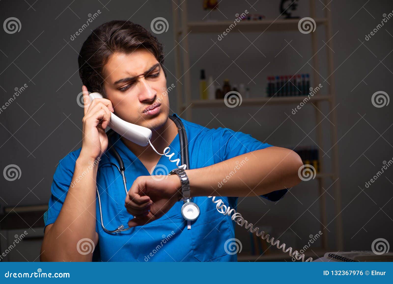 The Young Handsome Doctor Working Night Shift in Hospital Stock Photo ...