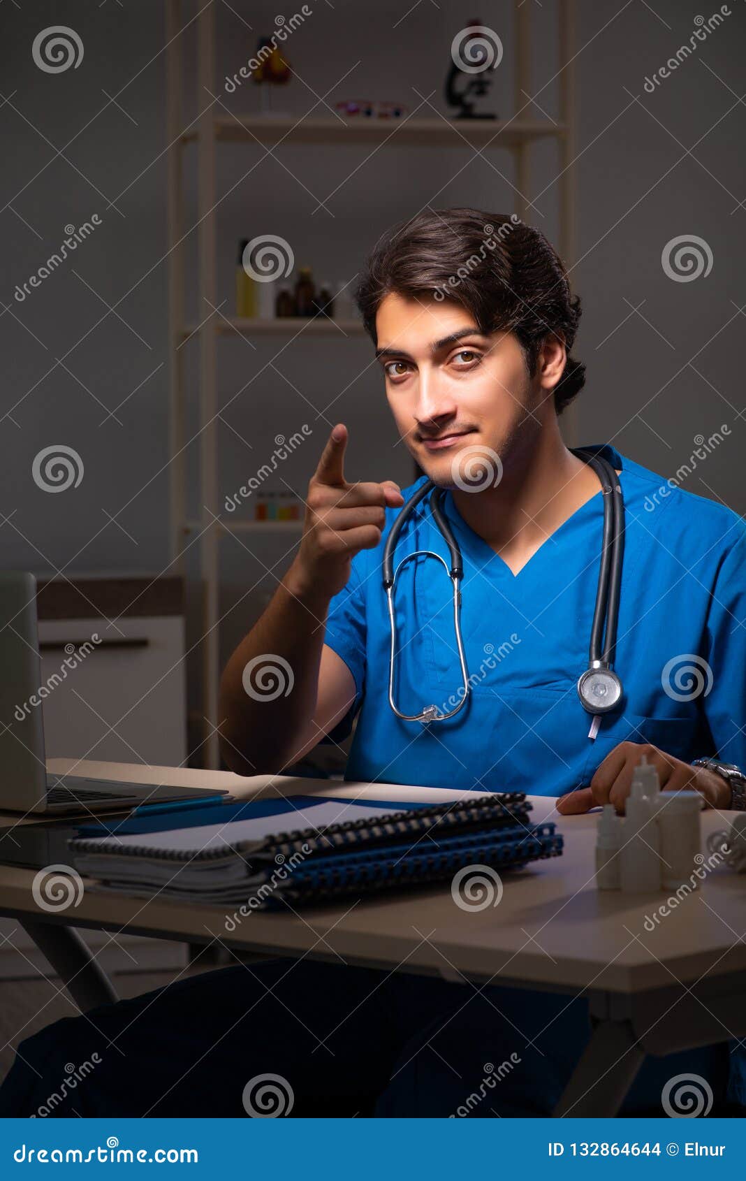 The Young Handsome Doctor Working Night Shift in Hospital Stock Photo ...
