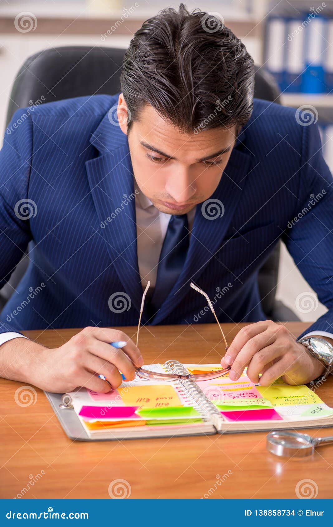 The Young Handsome Employee Planning His Work Activity Stock Photo ...