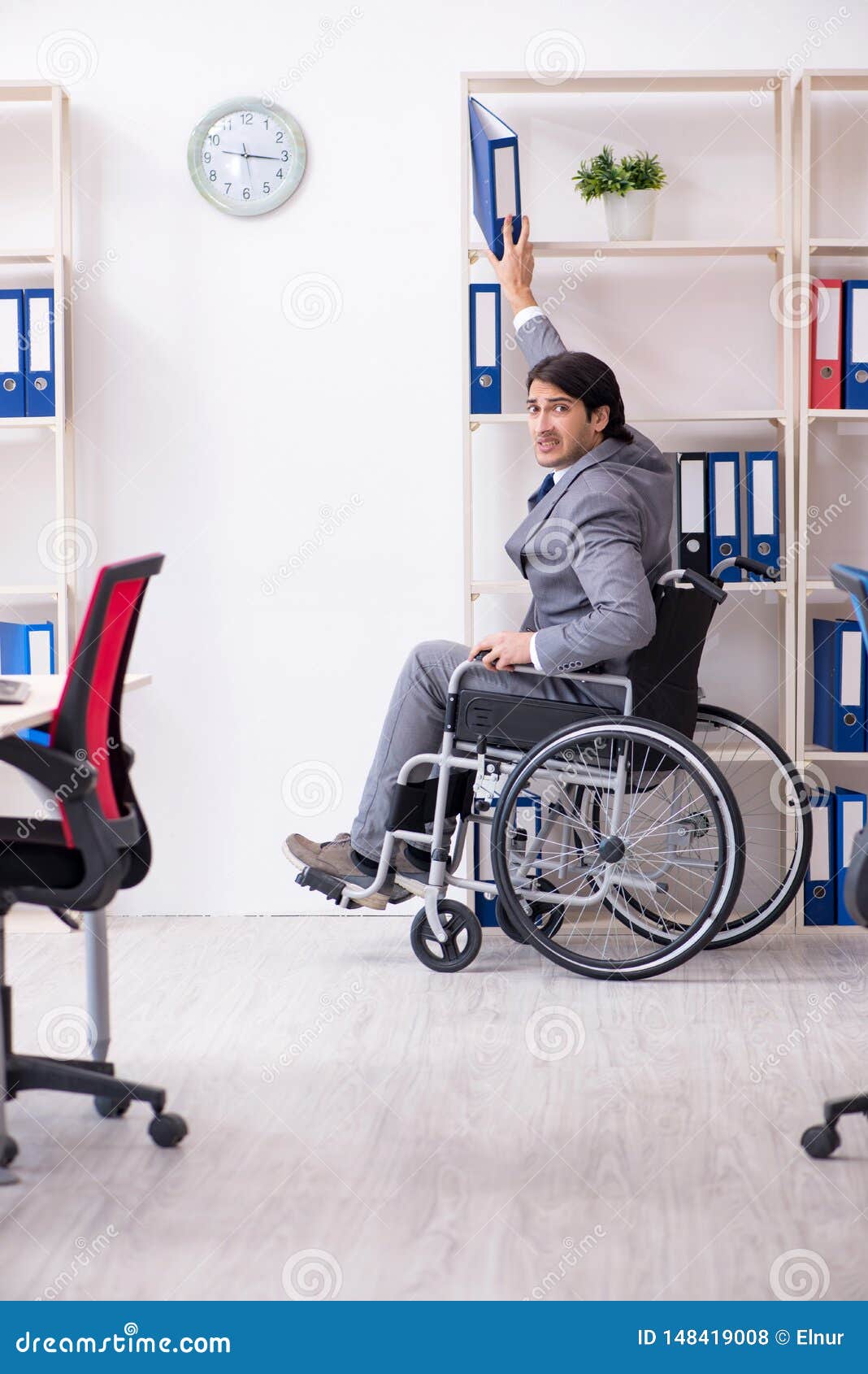 The Young Handsome Employee in Wheelchair Working in the Office Stock ...