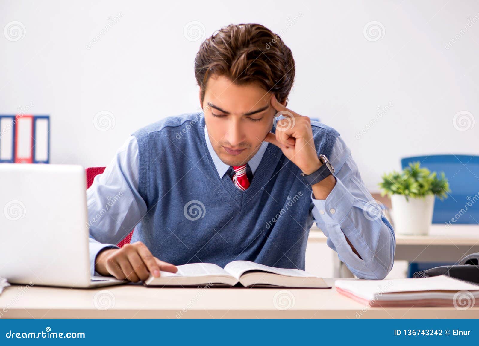 The Young Handsome Employee Working in the Office Stock Photo - Image ...