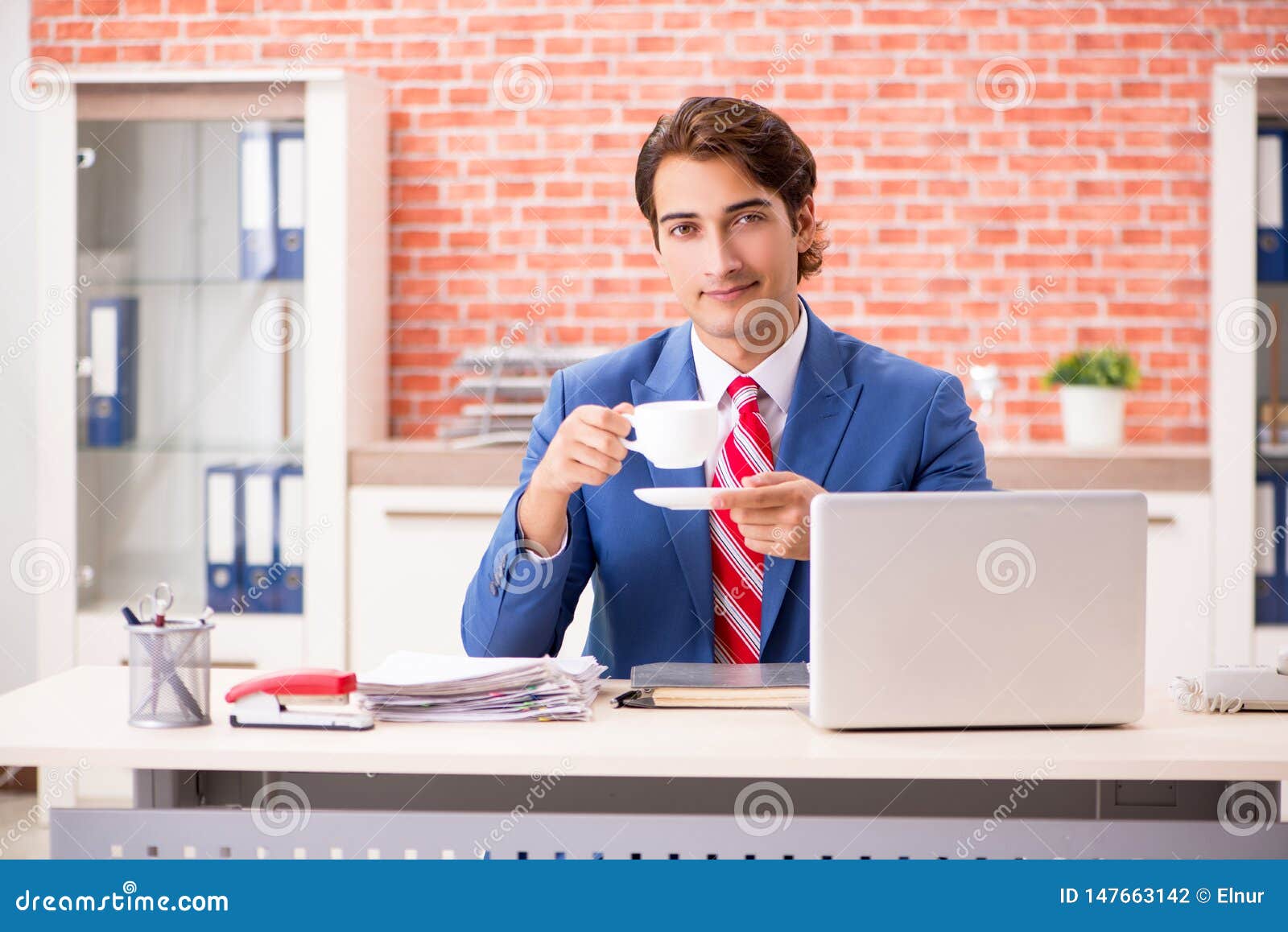 The Young Handsome Employee Working in the Office Stock Photo - Image ...