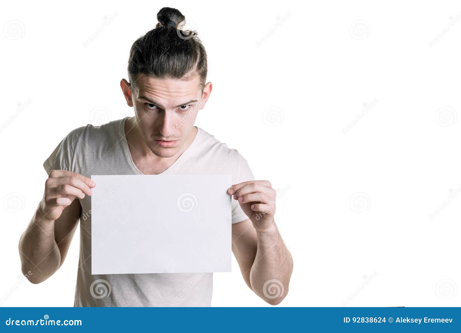 A Young Handsome Guy with a Blank Sheet of Paper Looking at a Sheet ...