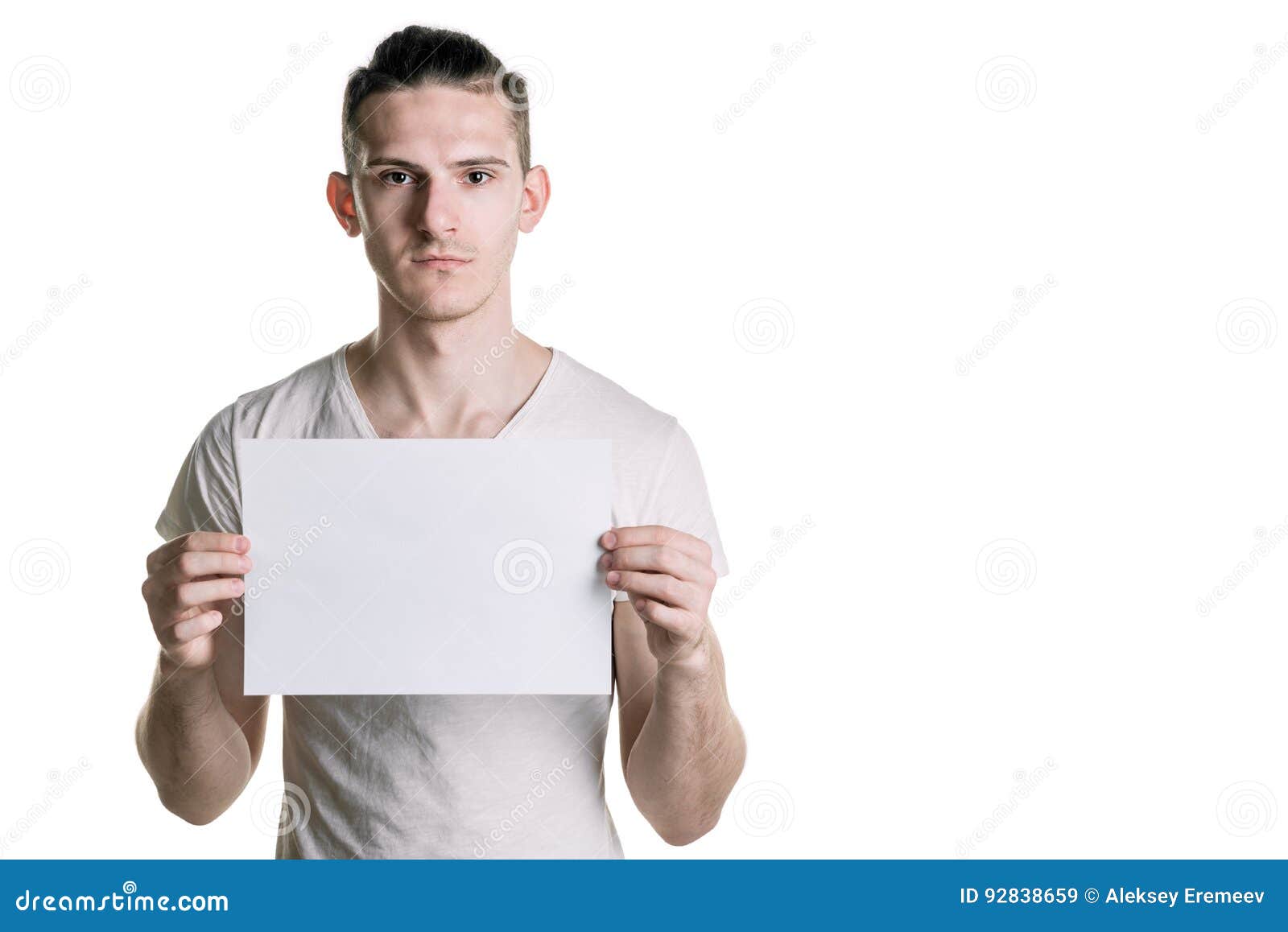 Young Handsome Guy with a Blank Sheet of Paper, Seriously Looking at ...