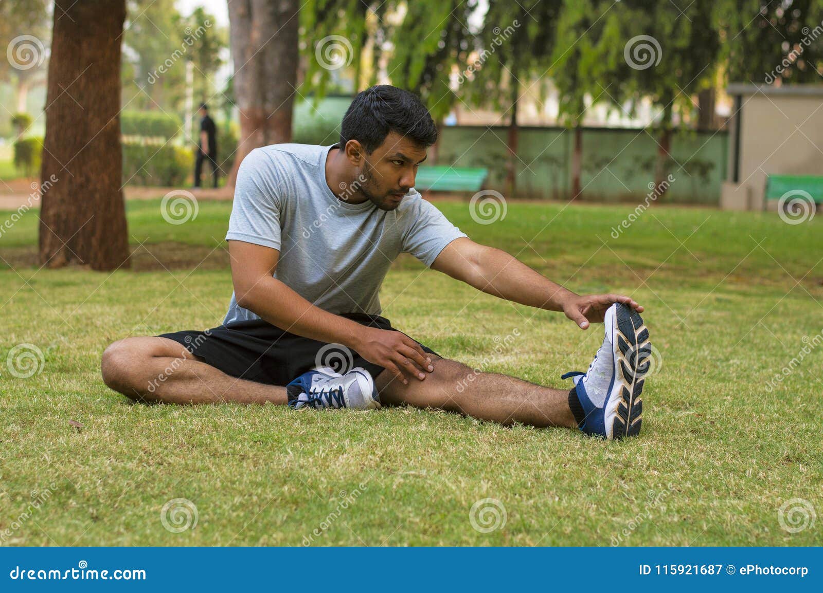 Young Guy Doing Stretching Exercise in a Park Stock Image - Image of ...
