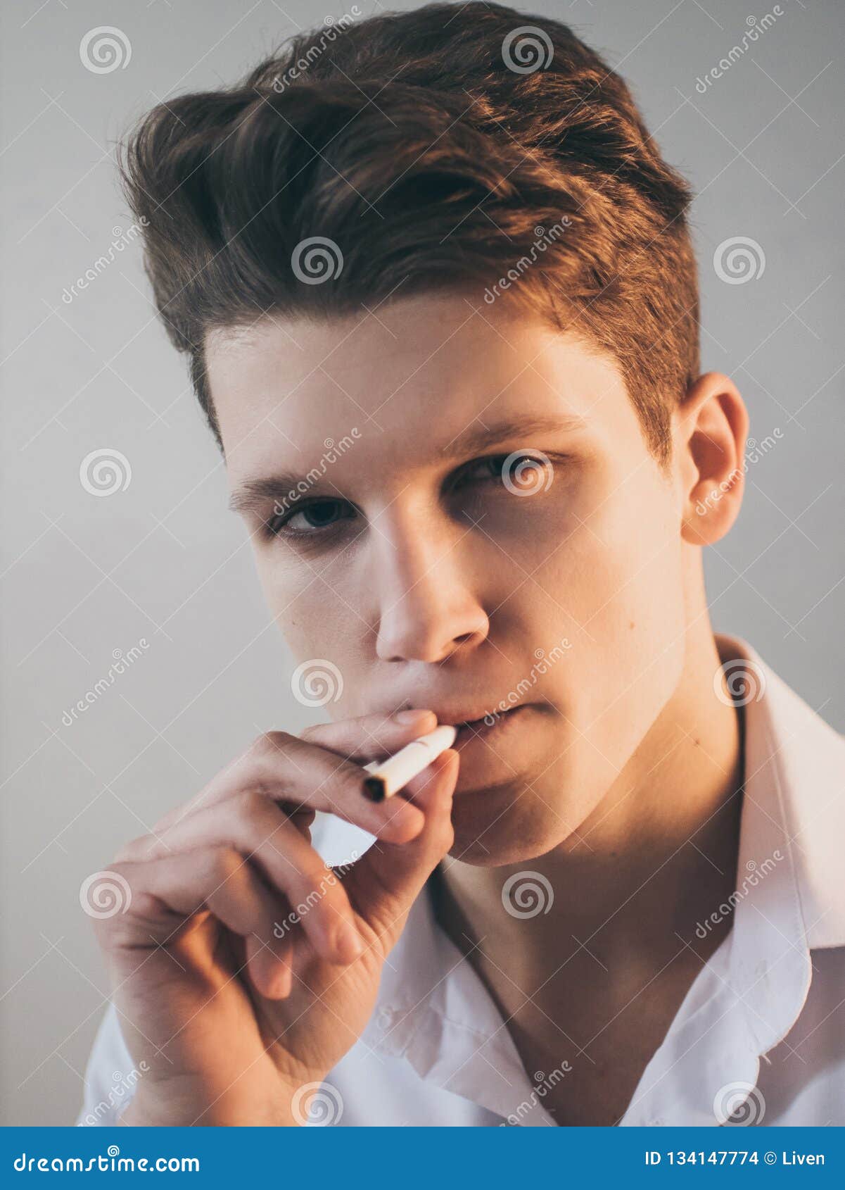 Young Handsome Guy Smoking a Cigarette, Studio Shooting Stock Photo ...