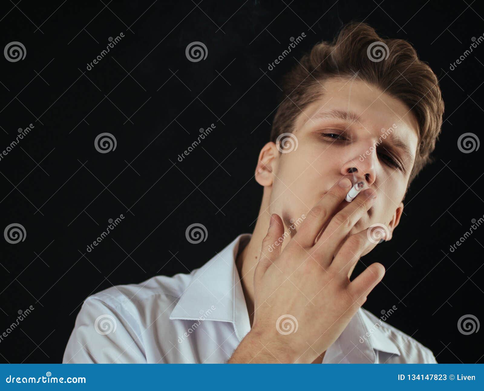 Young Handsome Guy Smoking a Cigarette, Studio Shooting Stock Image ...