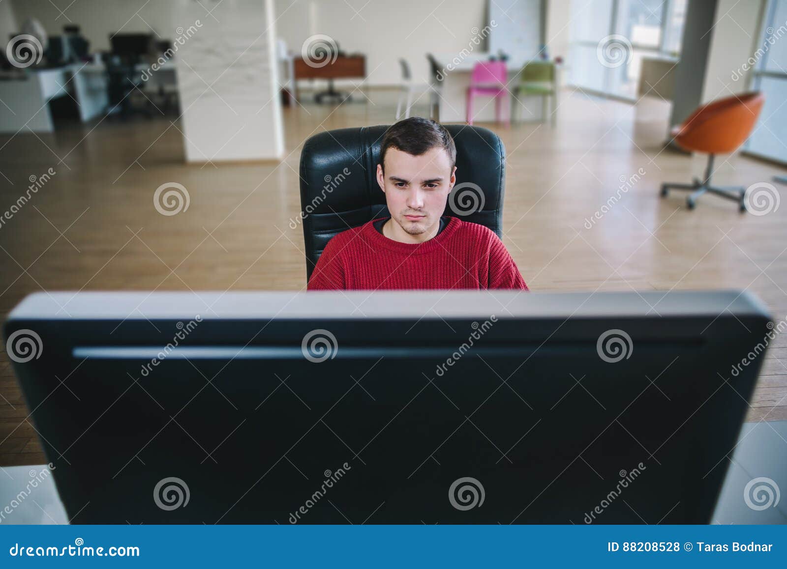 Young Handsome Hipster Programmer Sitting at a Large Computer Monitor ...