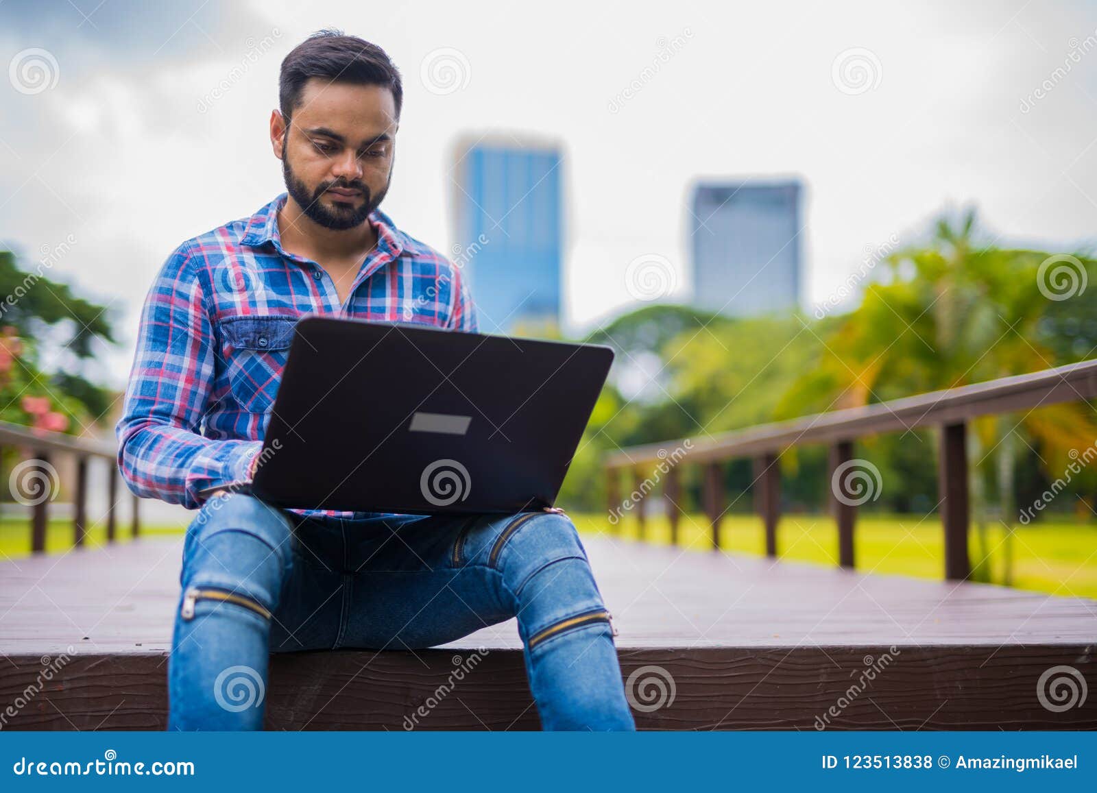 Young Handsome Indian Man in Park Using Laptop Computer Stock Photo ...