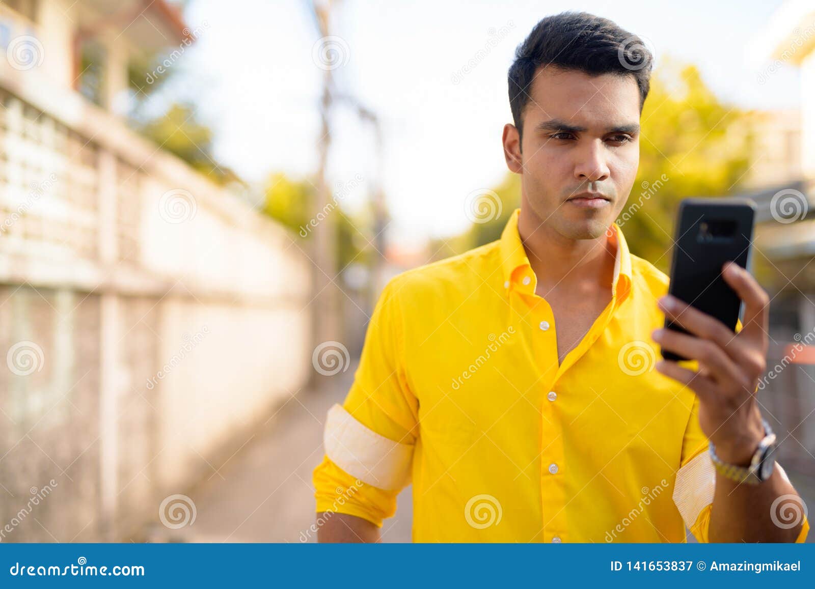 Young Handsome Indian Man Using Phone in the Streets Outdoors Stock ...